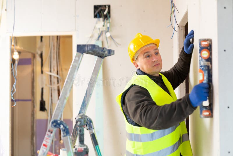 Builder Checks the Vertical of the Wall Using Level Stock Image - Image ...