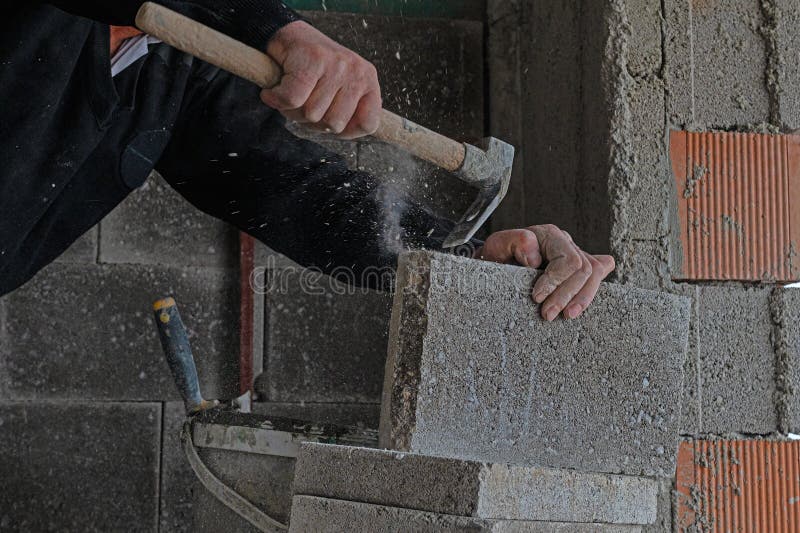 The Builder is Chiselling Bricks with a Chisel Stock Image - Image of ...