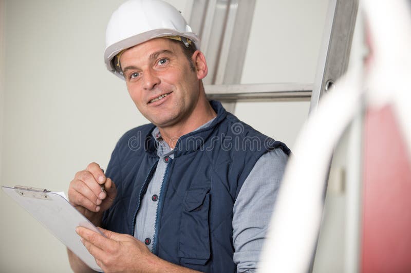 Builder in with Clipboard Looking at Camera Stock Photo - Image of ...