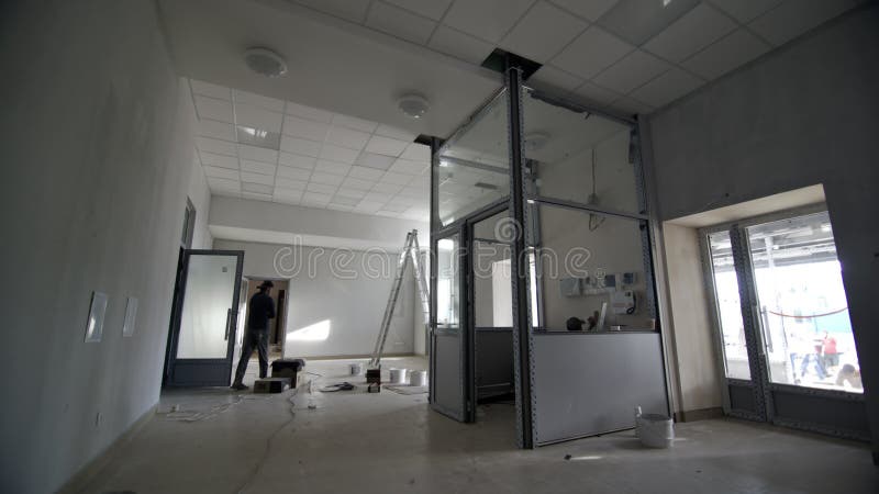 Builder Comes in Empty Renovated Hall with Watchman Cabin Stock Footage ...