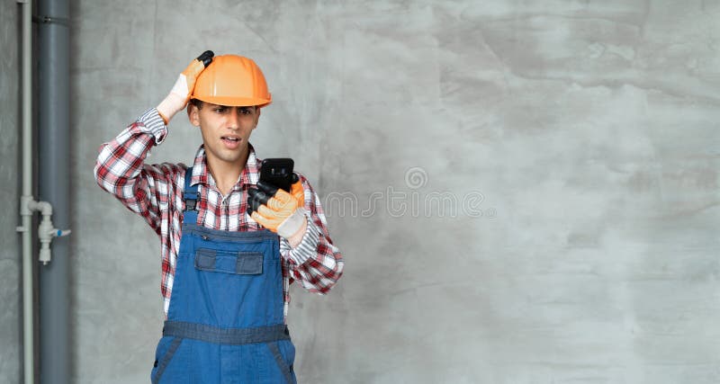 Builder Considered. Construction Worker is Holding Phone. Engineer ...
