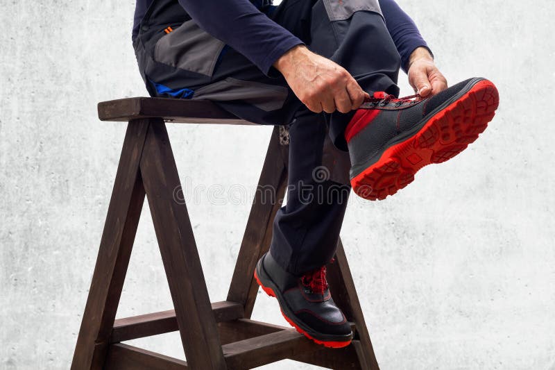 Builder, Construction Worker Putting on Shoes for Work Near Concrete ...