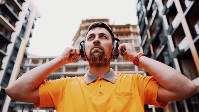 Builder Covers His Ears, Ear To Protect Workers Ears. Construction ...