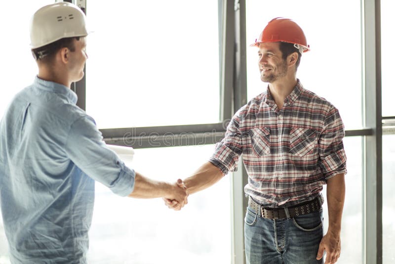 The Builder and the Customer Shake Hands on a Gray Background. the ...
