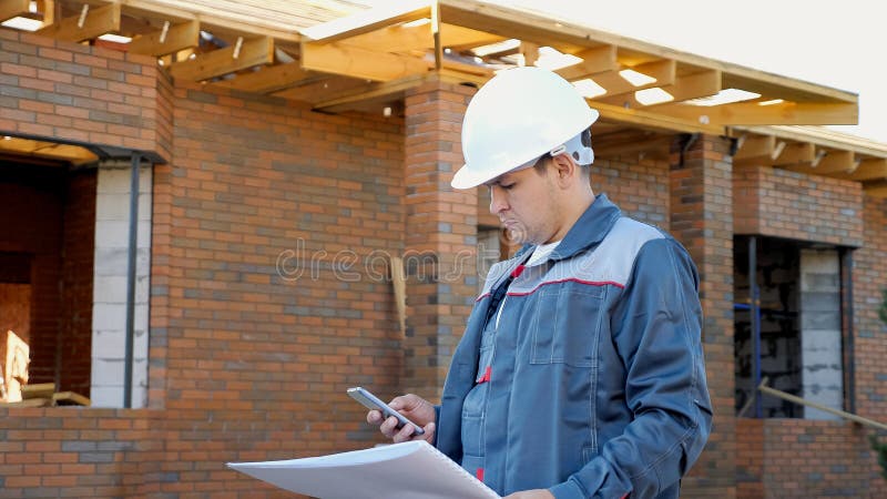 Man with Paper Draft in Building Under Construction Stock Image - Image ...