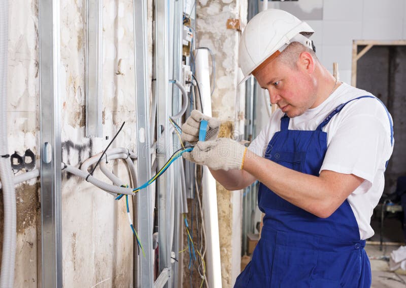 Builder Engaged in Electrical Installation Work Stock Photo - Image of ...