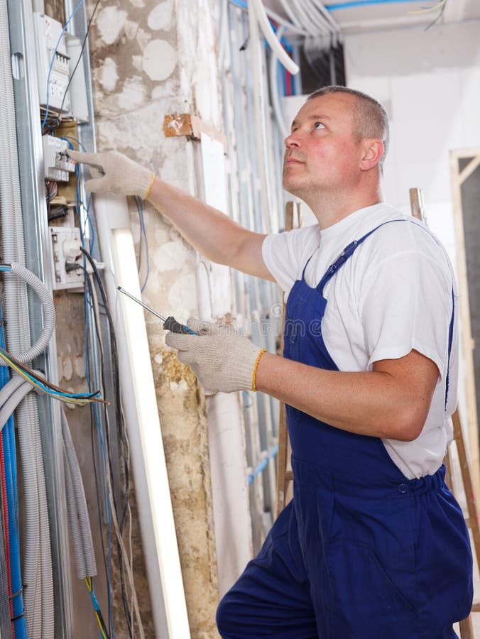 Builder Engaged in Electrical Installation Work Stock Photo - Image of ...