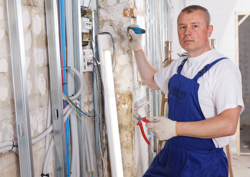 Builder Engaged in Electrical Installation Work Stock Image - Image of ...