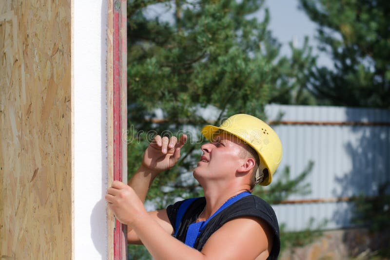 Builder Ensuring that a Beam is Vertical Stock Image - Image of ...