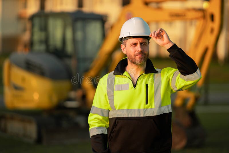 Builder on Excavator. Builder Worker with Excavator. Builder in Helmet ...