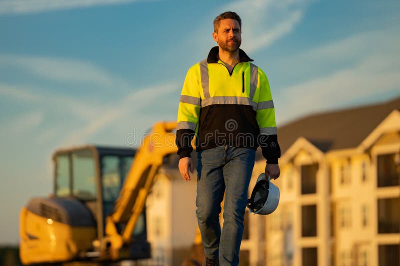 Builder on Excavator. Builder Worker with Excavator. Builder in Helmet ...