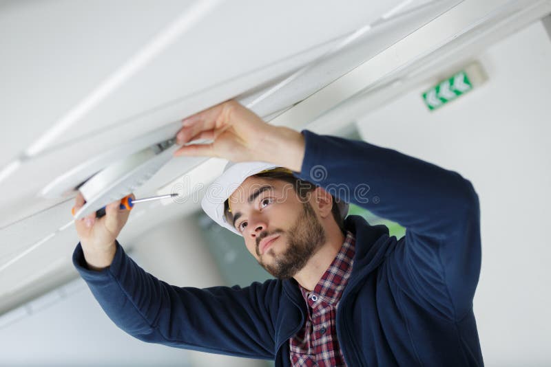 Builder Fixing Ceiling at Working Area Indoors Stock Photo - Image of ...