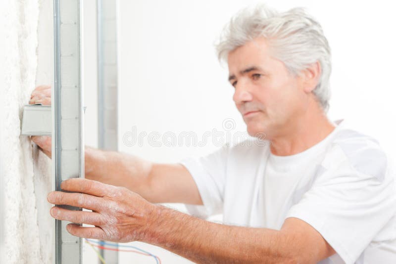 Builder Fixing Metal Studwork To Wall Stock Photo - Image of studwork ...