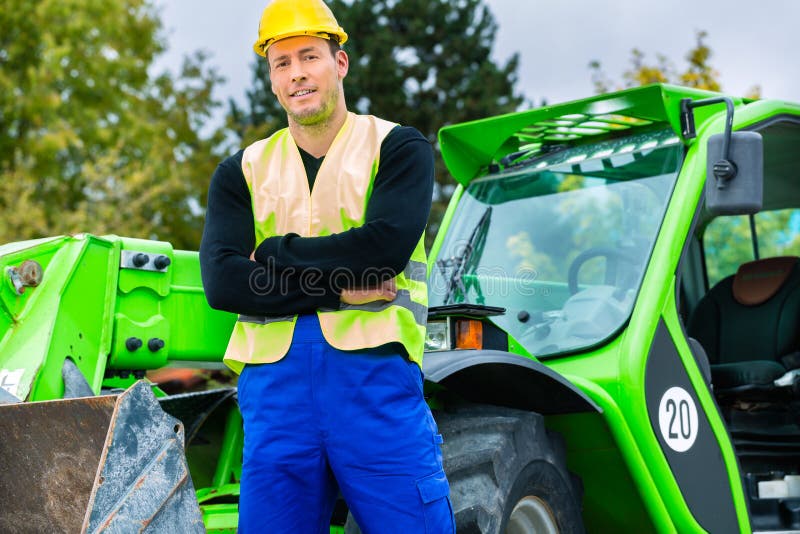 Builder in Front of Construction Machinery Stock Photo - Image of ...