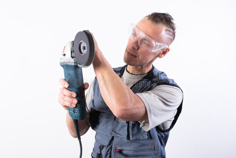 The Builder in Goggles, with an Angle Grinder in His Hands Stock Photo ...