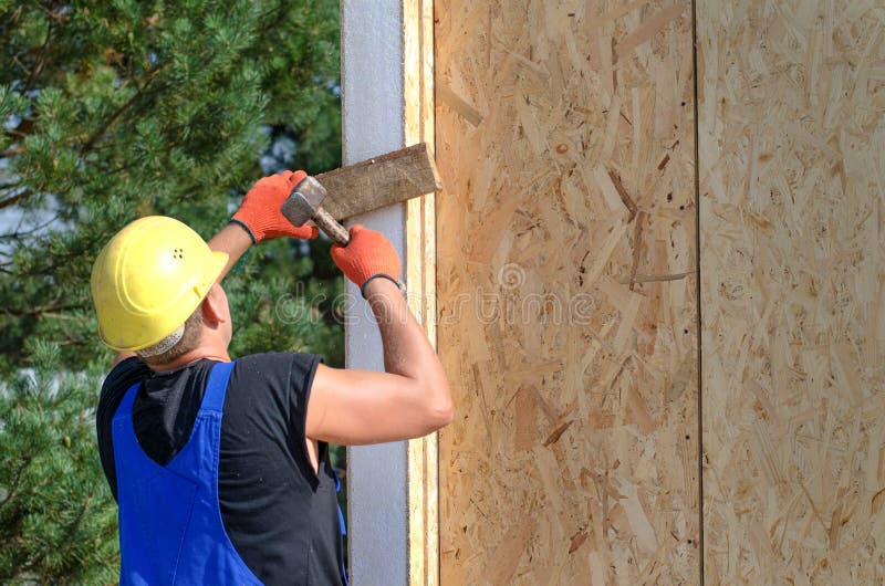 Builder Hammering on a Wooden Wall Panel Stock Photo - Image of ...