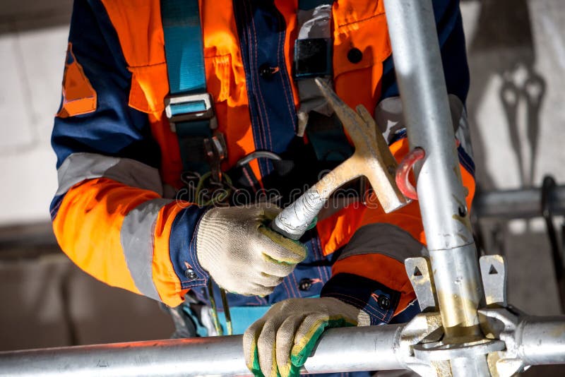 The Builder Hammers the Fixing Pin with a Hammer Stock Photo - Image of ...