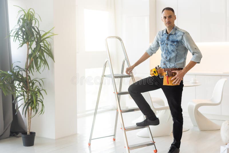 Builder Handyman with Construction Tools. House Renovation Background ...