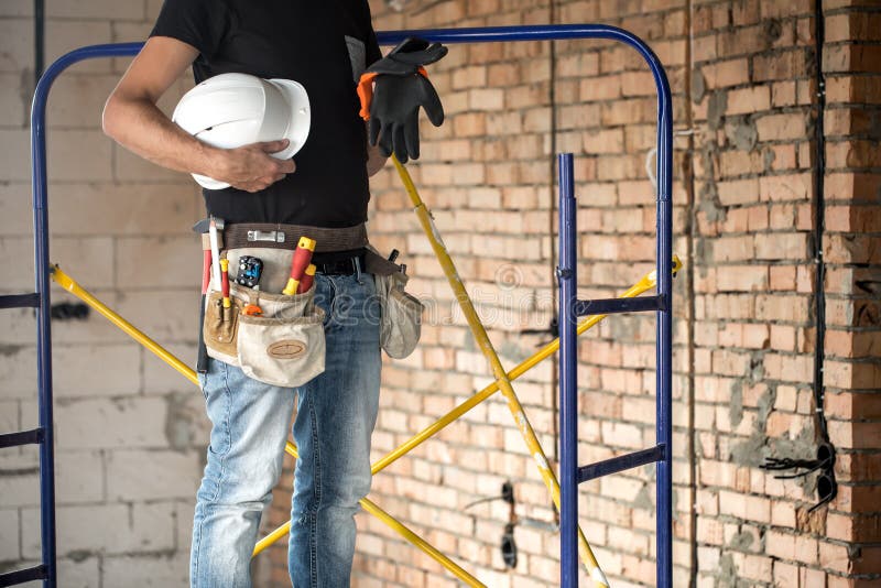 Builder Handyman with Construction Tools. House and House Renovation ...