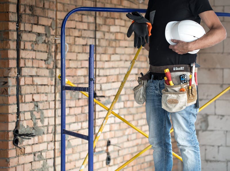 Builder Handyman with Construction Tools. House and House Renovation ...