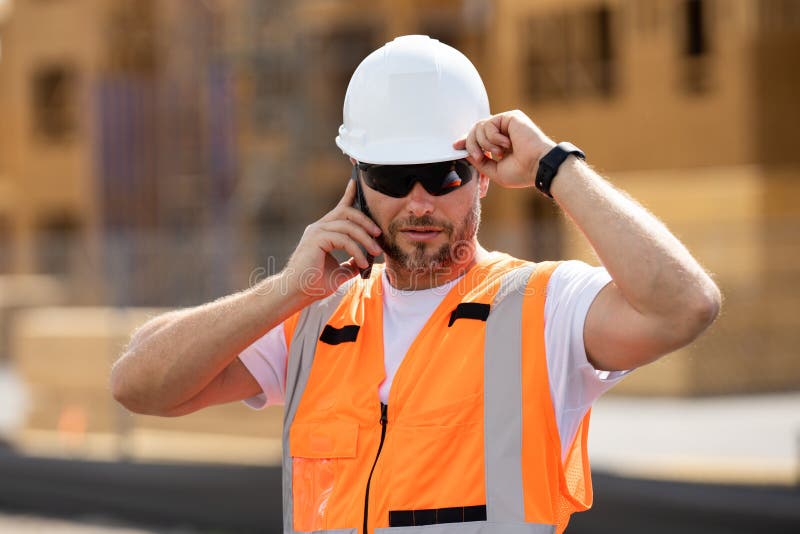 Builder in a Hard Hat Working on a Construction Project at a Site ...