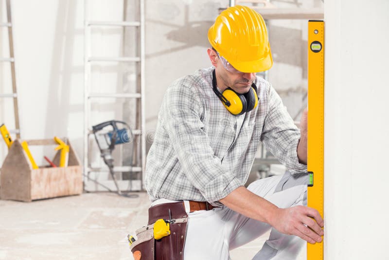 Builder Using a Spirit Level To Measure a Wall Stock Image - Image of ...
