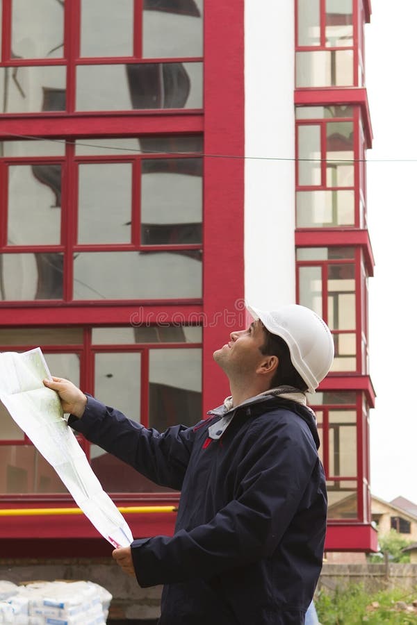 Builder in Helmet with Blueprint on Building Site Stock Photo - Image ...