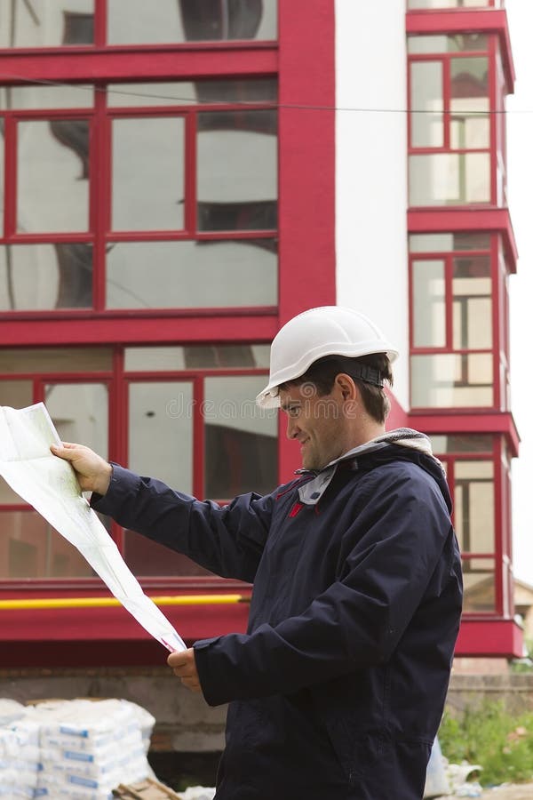 Builder in Helmet with Blueprint on Building Site Stock Photo - Image ...