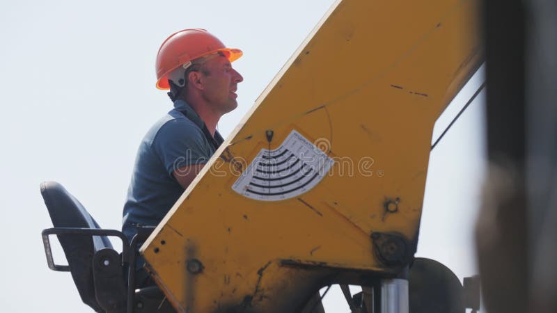 Builder with Helmet Controls Crane at Construction Site Stock Footage ...