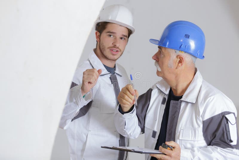 Builder and his apprentice stock photo. Image of builder - 159686888
