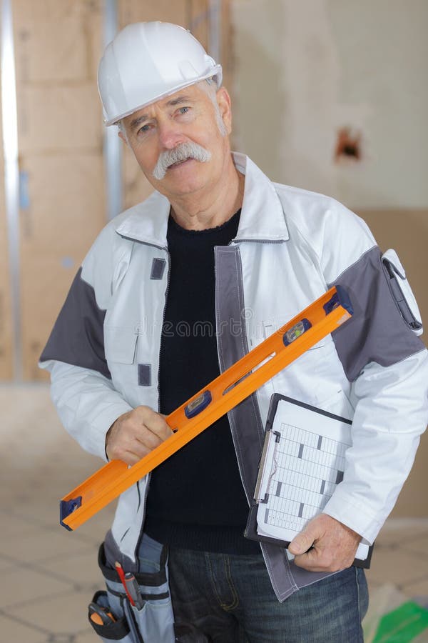 Builder Holding Building Level at Construction Site Stock Photo - Image ...
