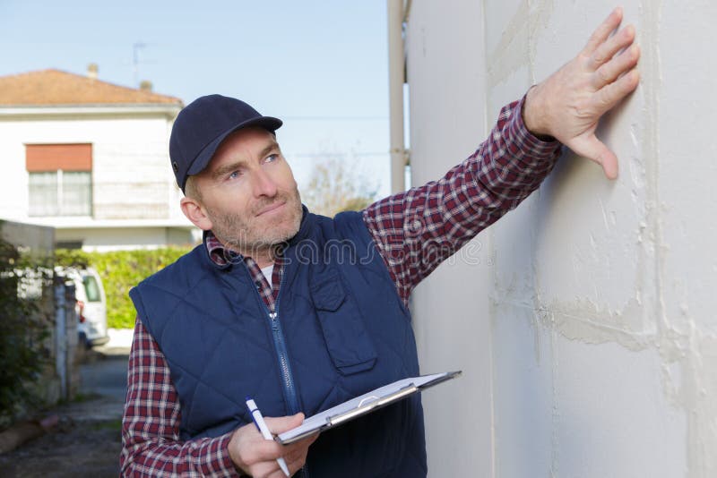 Builder inspecting house stock image. Image of checking - 269021933