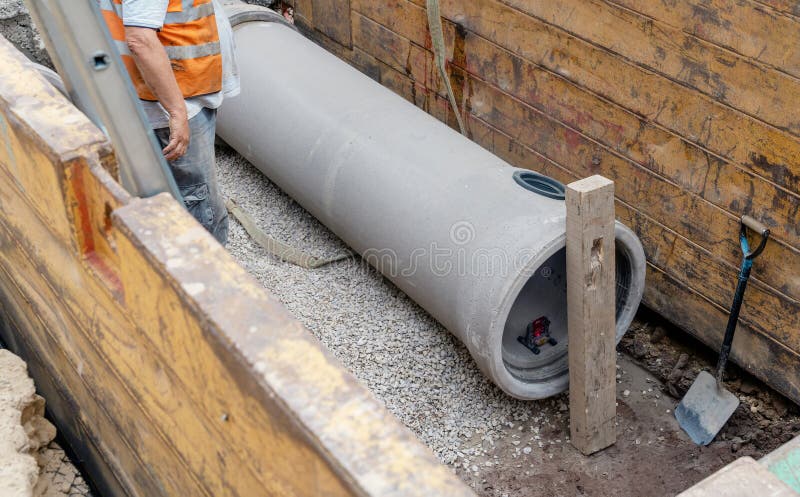 Builder Installing Big Diameter Concrete Drainage Pipe Protected by ...