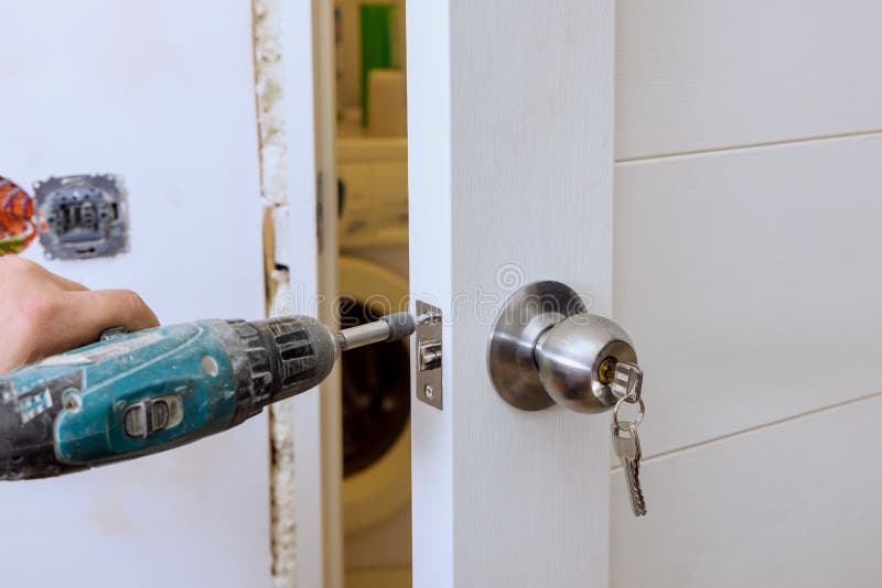 Builder in Installing a Door Lock the Door of a New House Stock Image ...