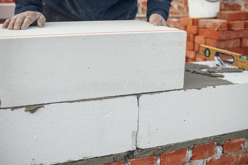 Builder Installing Masonry White Blocks Close Up. Worker Laying ...