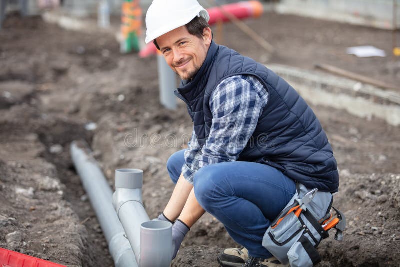 Builder Installing Waste Pipes Outdoors Stock Photo - Image of sewer ...