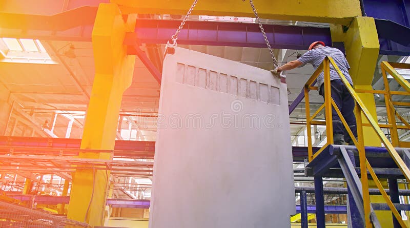 A Builder Installs a Concrete Floor Slab Panel at a Construction Site ...