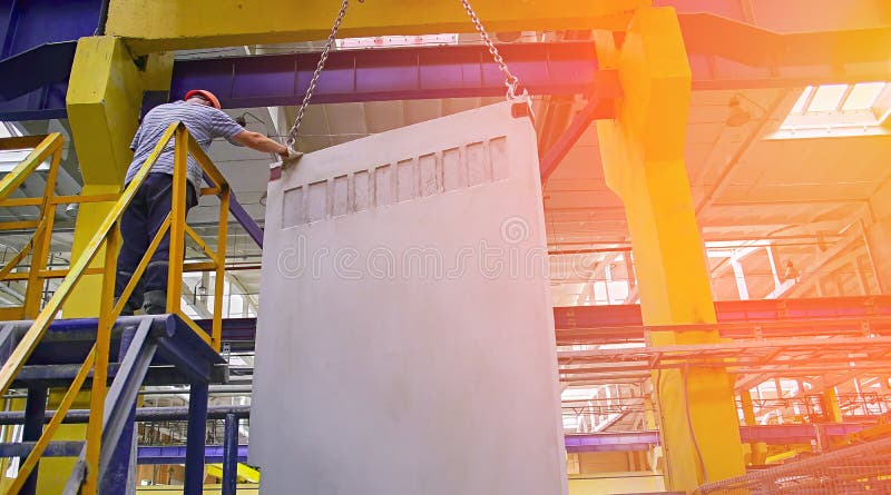 A Builder Installs a Concrete Floor Slab Panel at a Construction Site ...