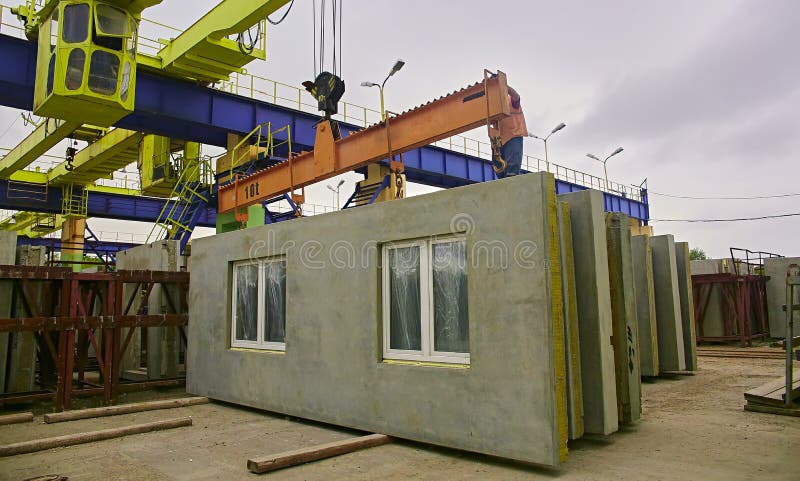 A Builder Installs a Concrete Floor Slab Panel at a Construction Site ...