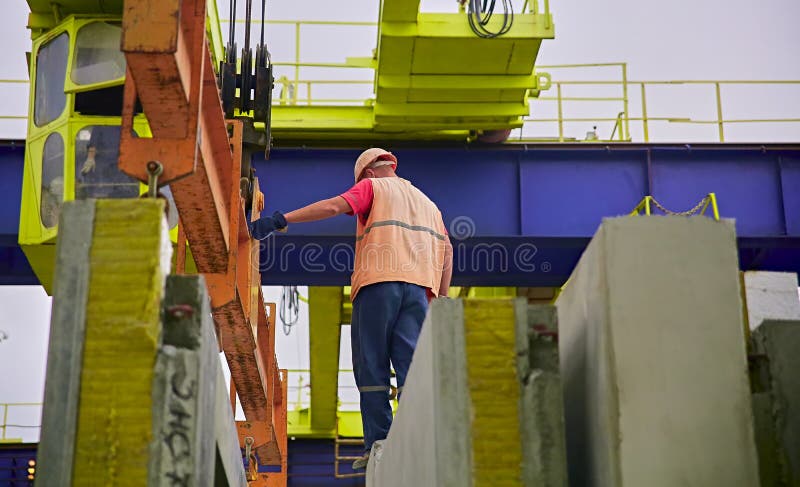A Builder Installs a Concrete Floor Slab Panel at a Construction Site ...