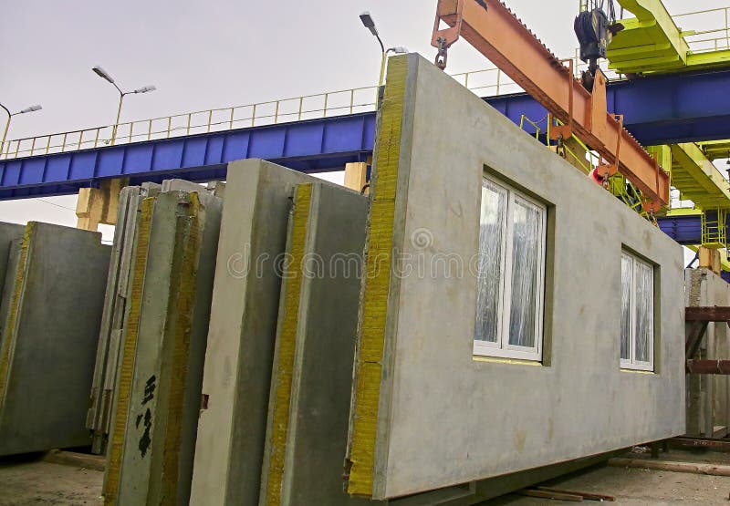 A Builder Installs a Concrete Floor Slab Panel at a Construction Site ...
