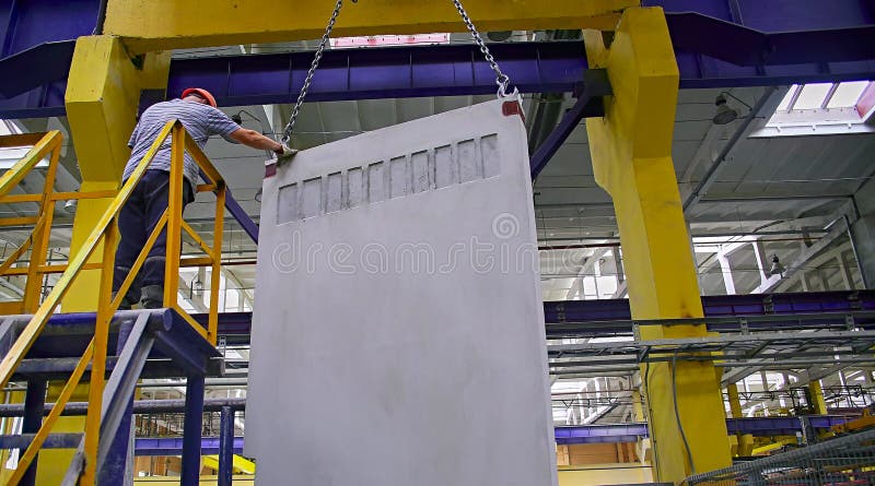 A Builder Installs a Concrete Floor Slab Panel at a Construction Site ...