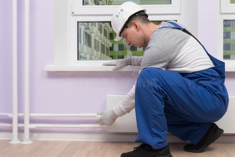 The Builder Installs a Regulator for the Heating System of a ...