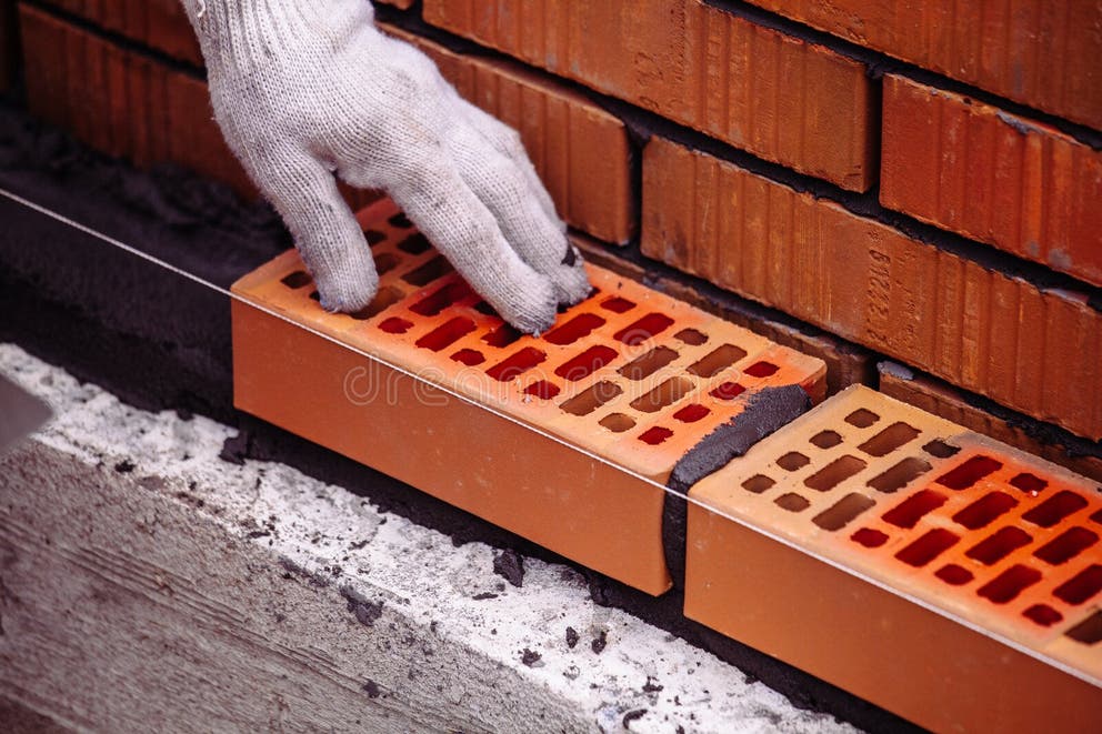 Builder Laying Bricks on Construction Site Stock Photo - Image of ...