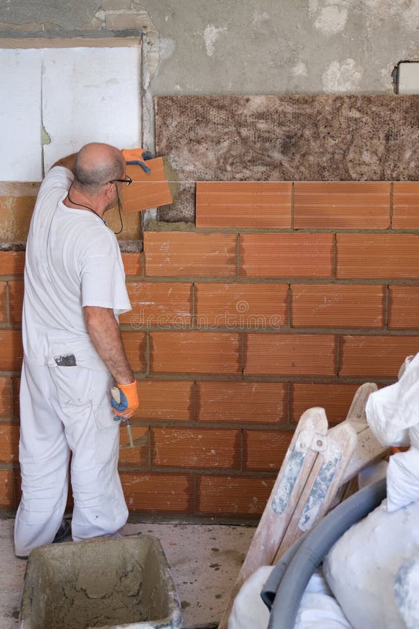 Builder Laying Bricks after Placing an Acoustic and Thermal Insulation ...