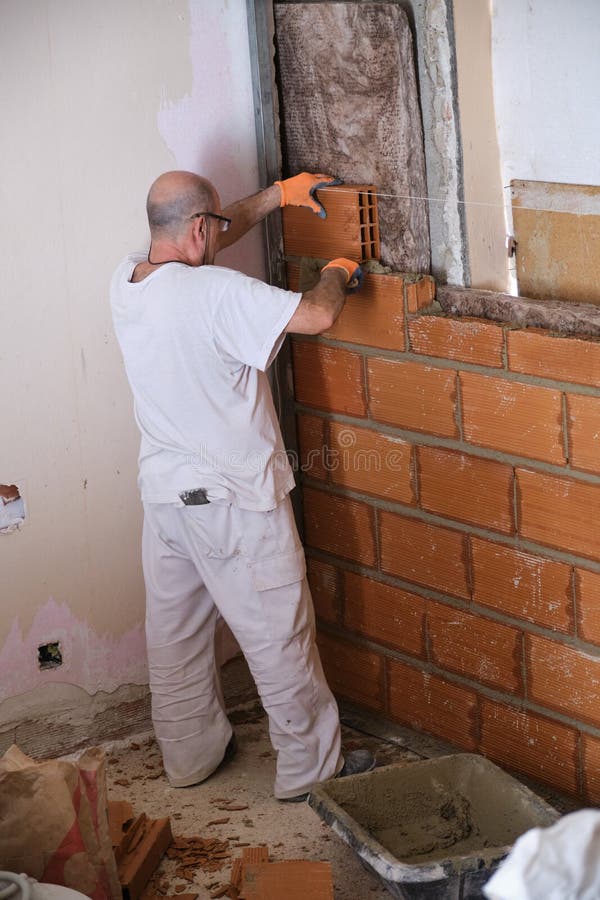 Builder Laying Bricks after Placing an Acoustic and Thermal Insulation ...