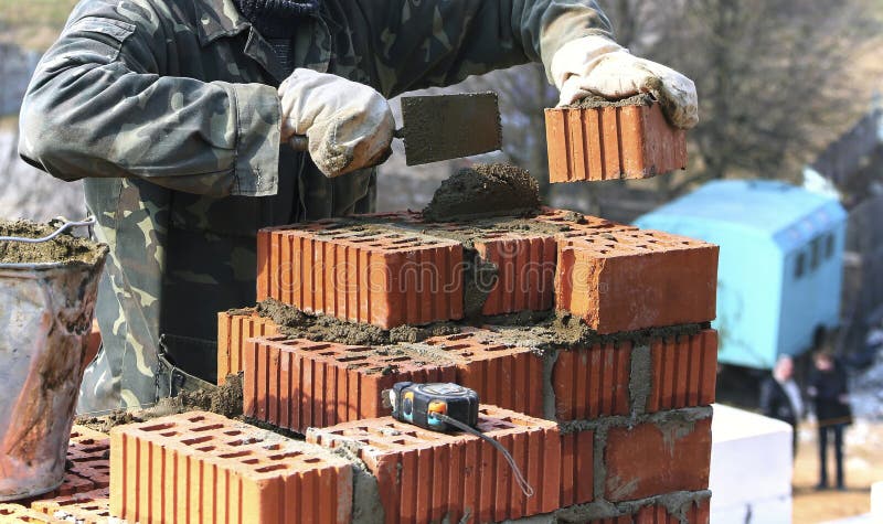 Builder Lays Bricks Meticulously while Constructing a Wall in an ...