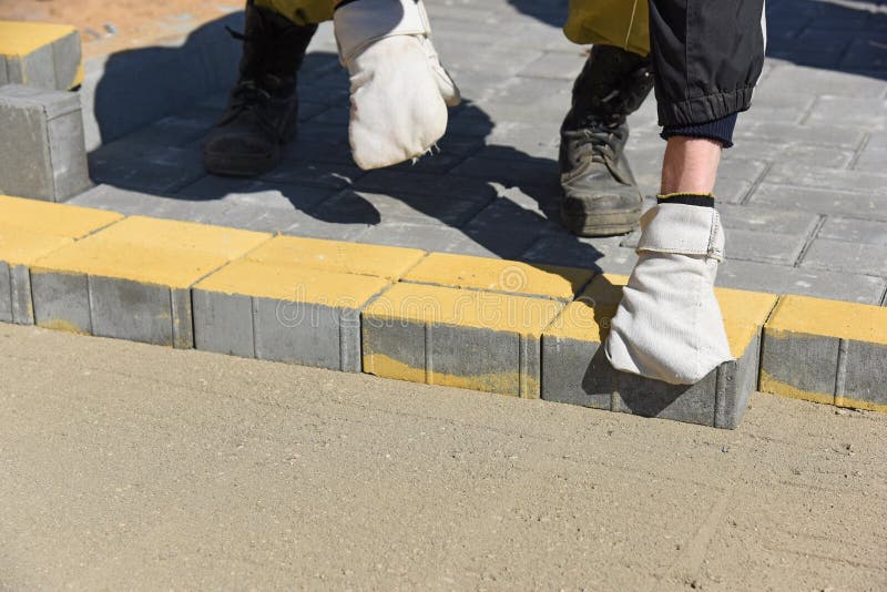 The Builder Lays Concrete Blocks on the Ground. Stock Photo - Image of ...