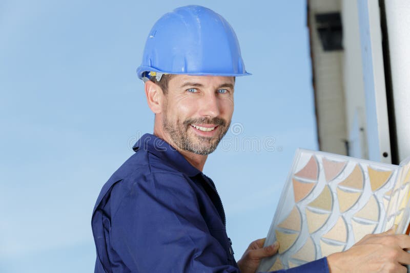 Builder Looking at Colour Samples for Building Exterior Stock Image ...