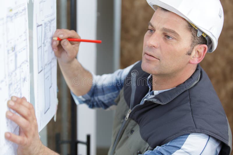Builder Looking and Hand Writting on Plan Stock Image - Image of room ...